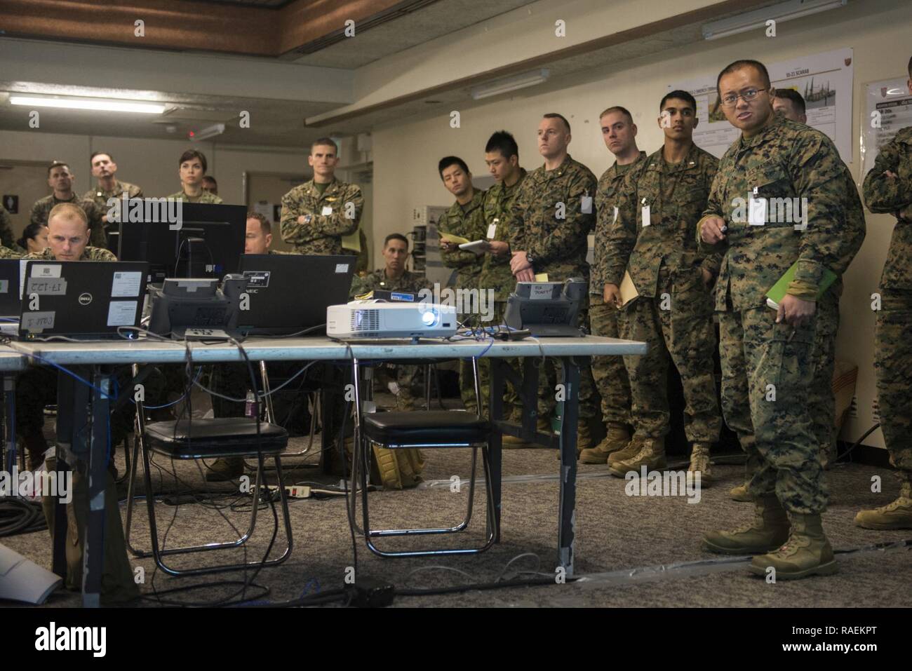 U.S. Marine 2nd Lt. Scott Yap, right, gives his brief to the staff as ...