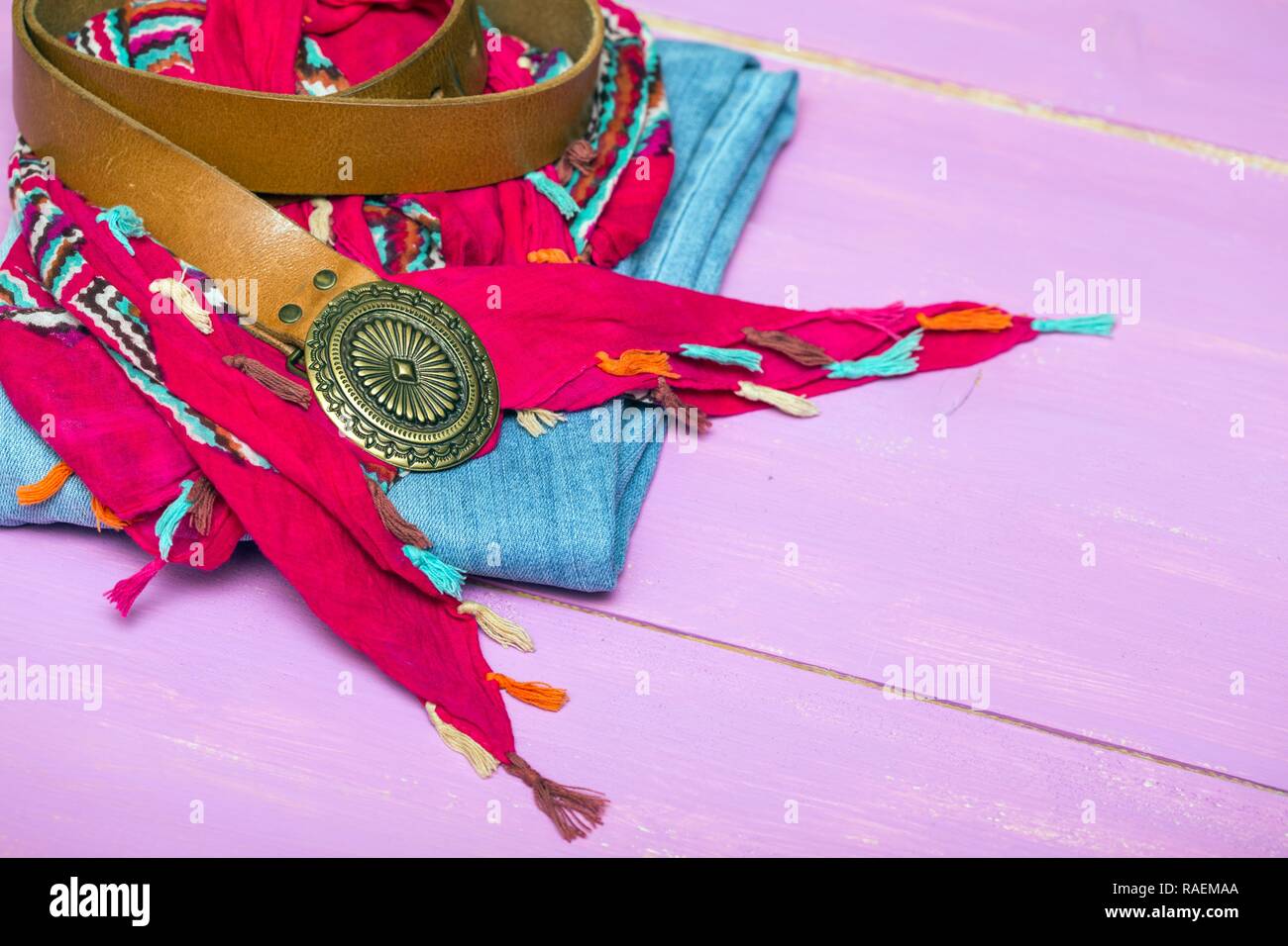 accessories on a lilac background - scarf, belt, jeans Stock Photo - Alamy