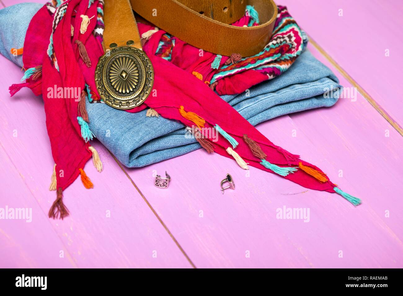 accessories on a lilac background - scarf, belt, jeans Stock Photo - Alamy