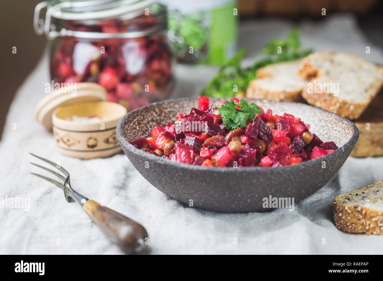 Russian beetroot salad vinaigrette in a bowl with rye bread, rustic ...