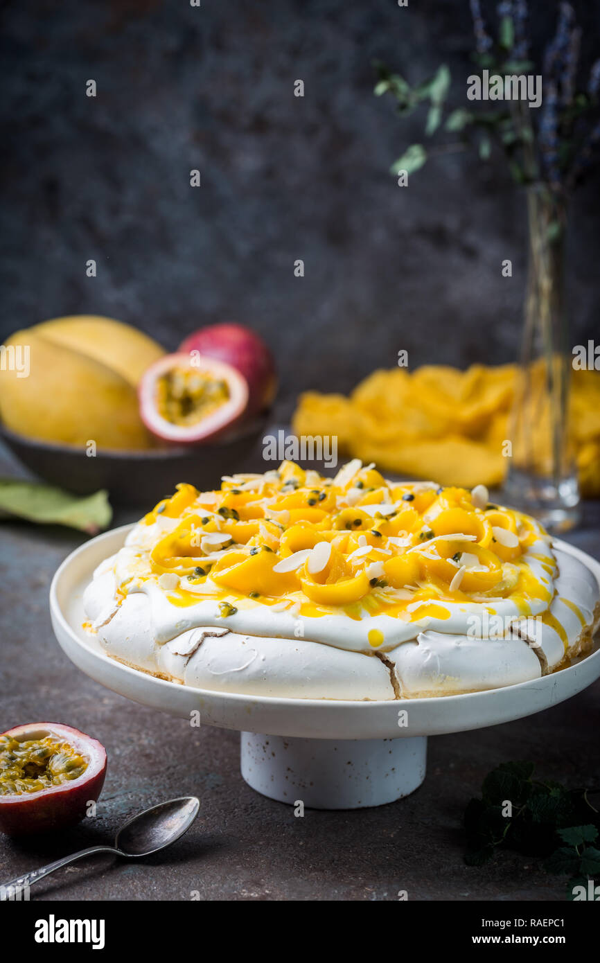 Meringue cake Pavlova with fresh mango and passion fruit and whipped ...
