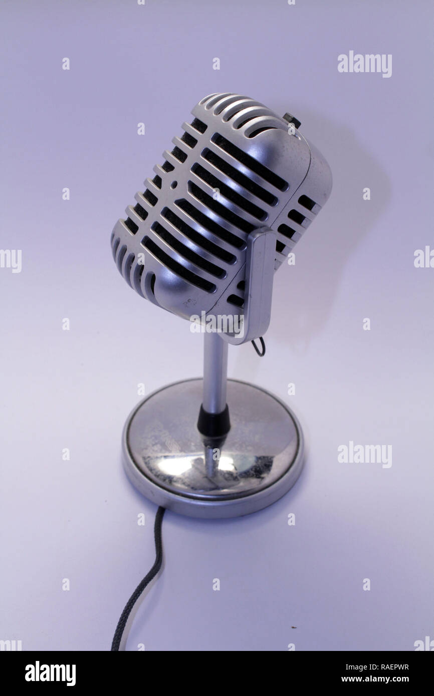 A mic, mike, or microphone with its cable. Taken with white background ...