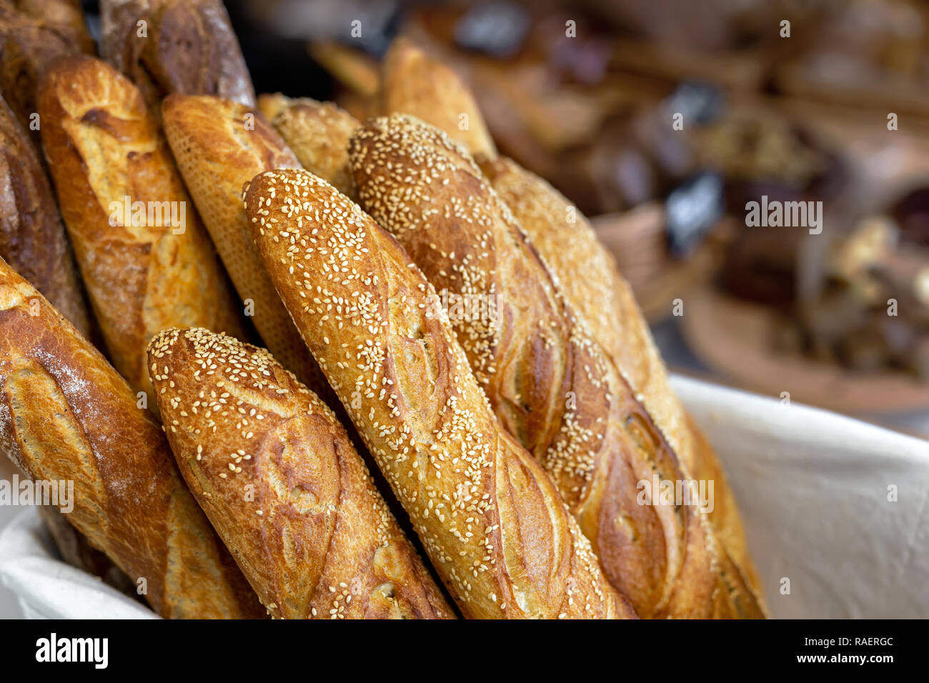 Traditional crusty French bread baguette in basket at bakery. Fresh ...