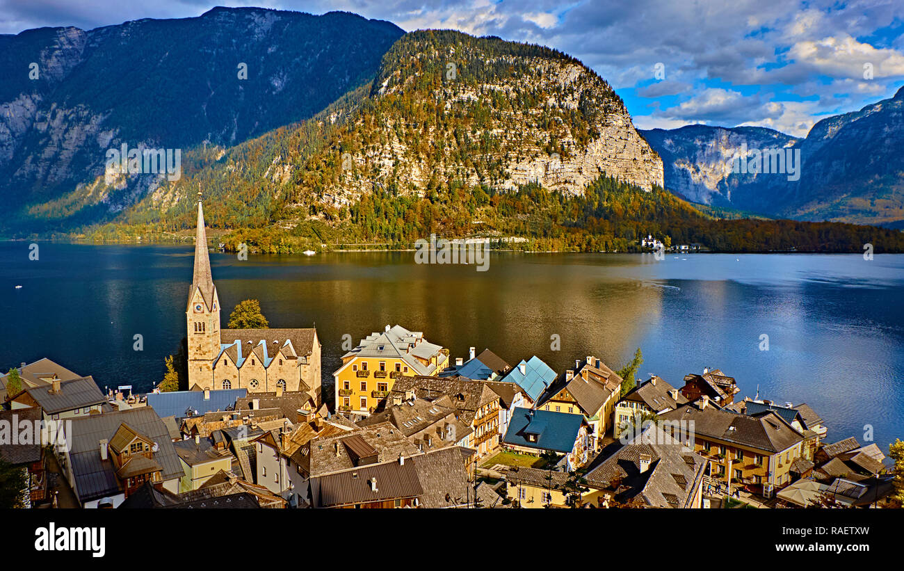 Panoramic scenic view in Austrian alps. Hallstatt mountain village at Hallstatt lake. Sunny day ...