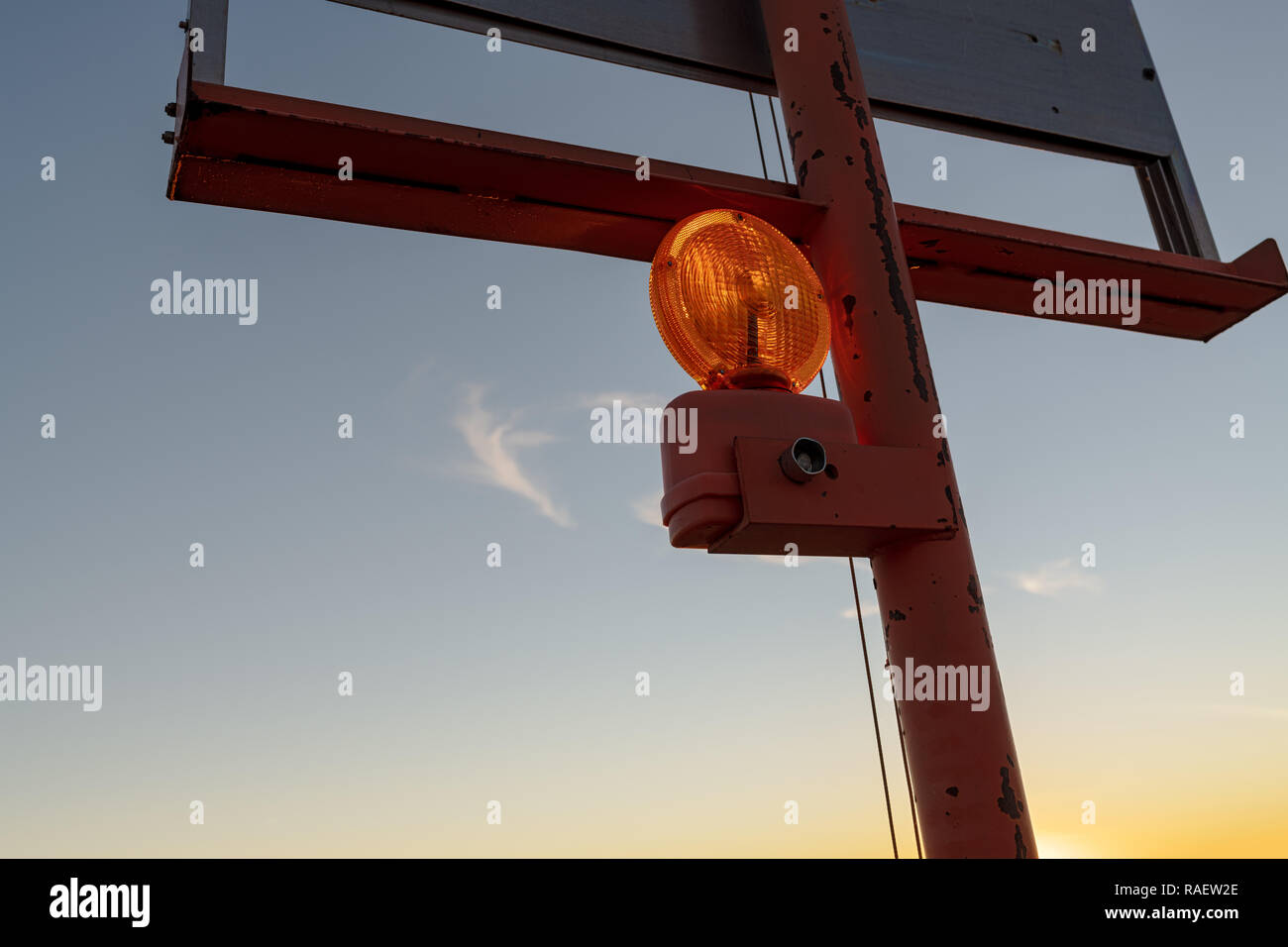 Backlit highway construction warning light at sunset Stock Photo - Alamy