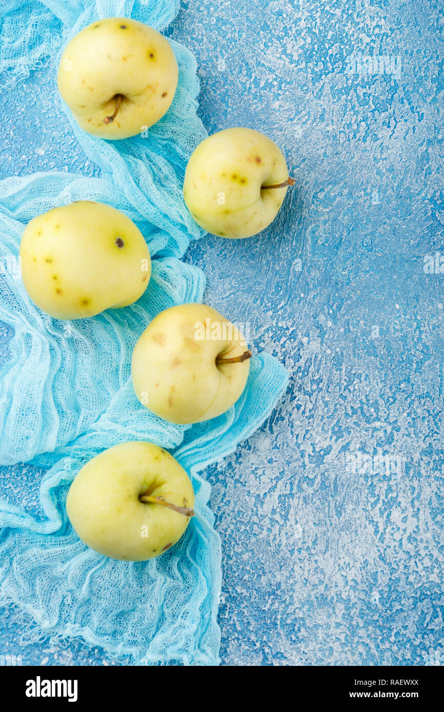 Fresh green apples on light blue background Stock Photo - Alamy