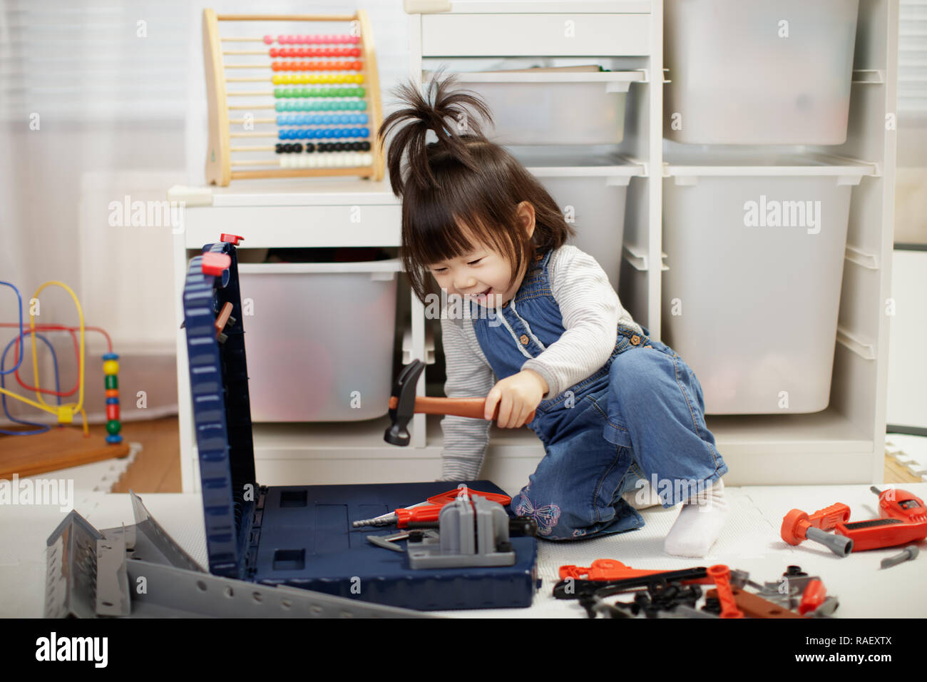 toddler baby girl pretend play DIY tools Stock Photo - Alamy