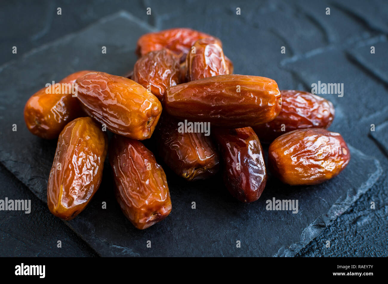 Dried date on black stone background. Heap of dates close up. Healthy ...