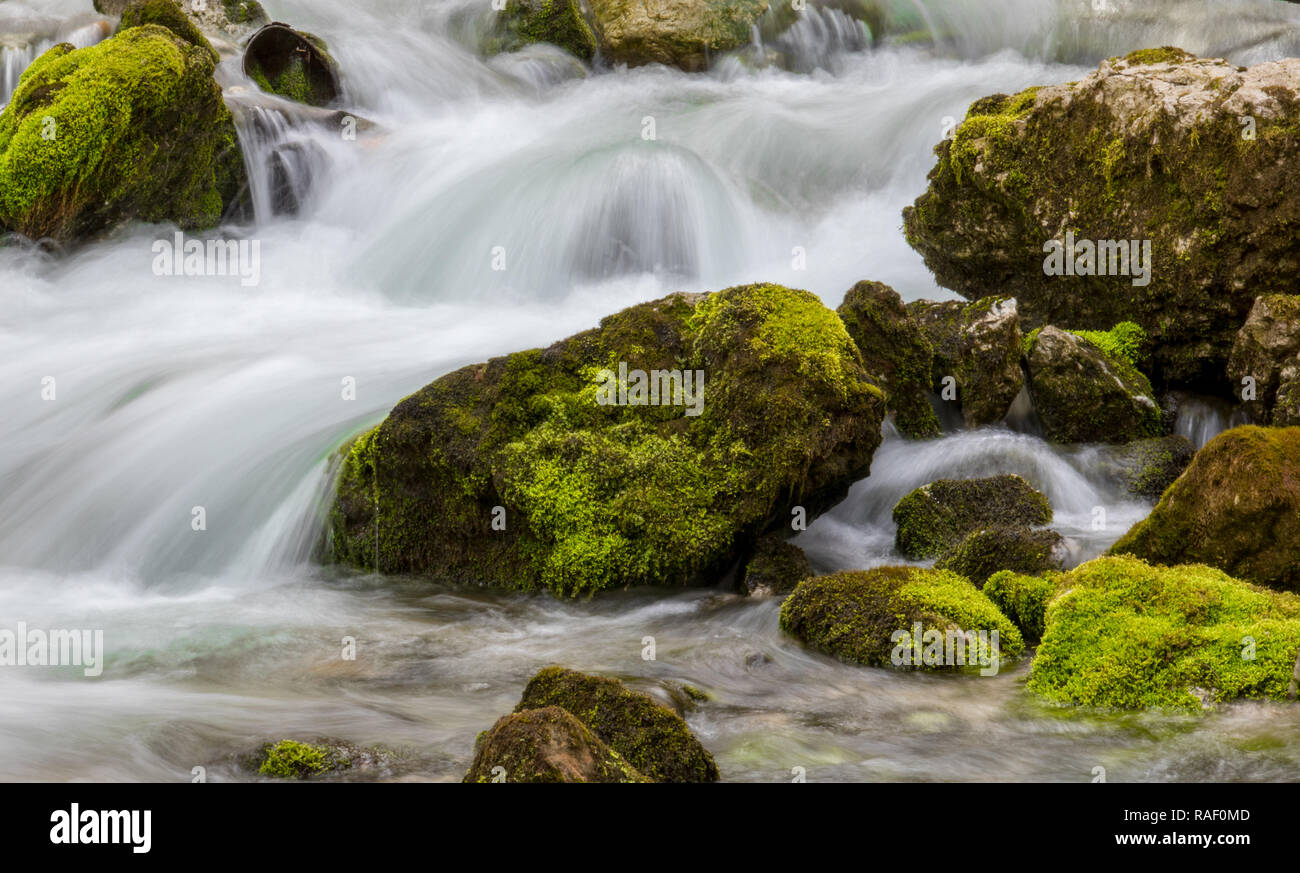 water flowing over rocks filled with moss Stock Photo - Alamy
