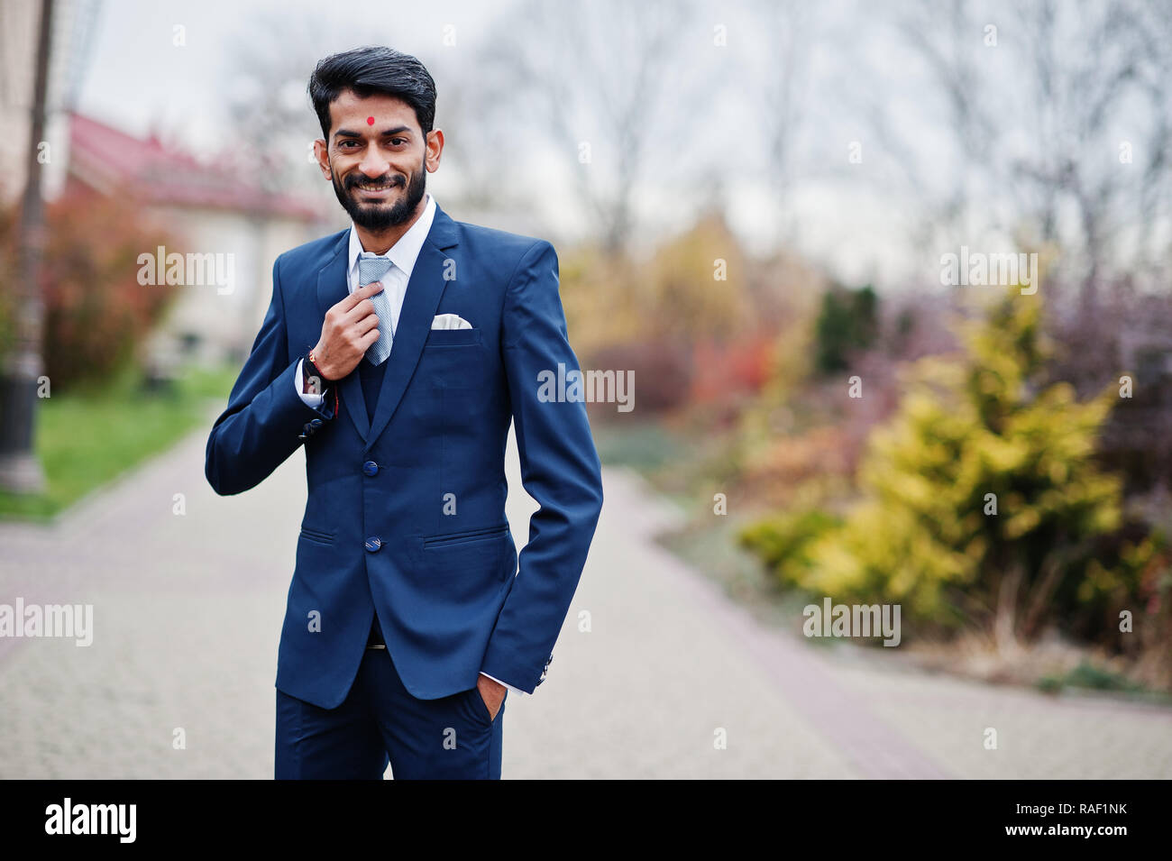Stylish beard indian man with bindi on forehead, wear on blue suit ...