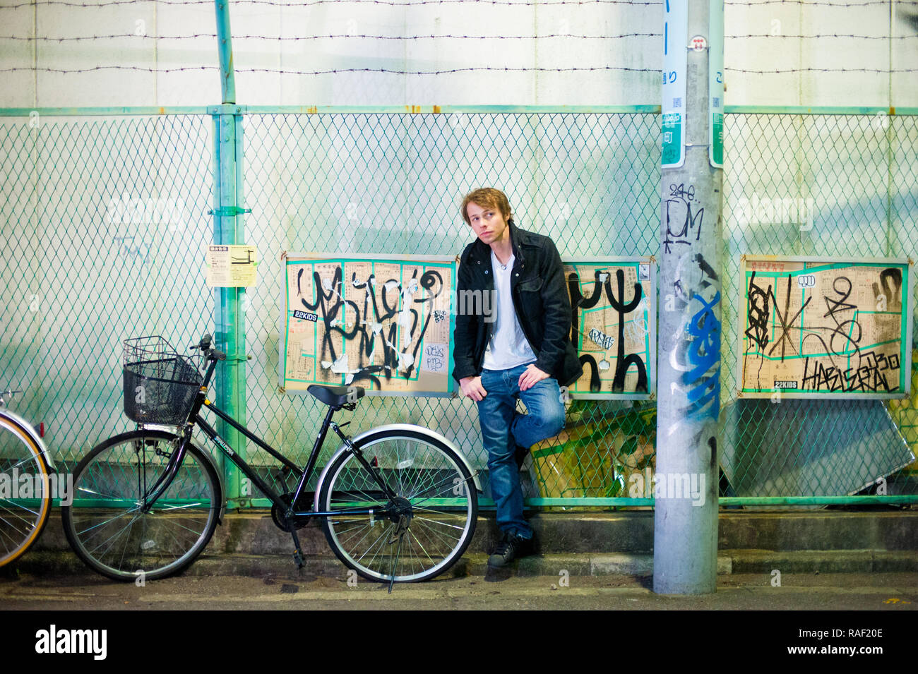 Caucasian male model poses for pictures on the street Stock Photo - Alamy