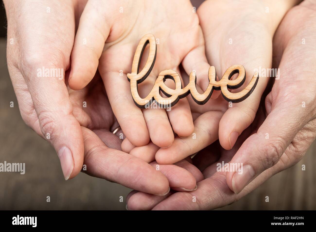 hands holding word love Stock Photo - Alamy