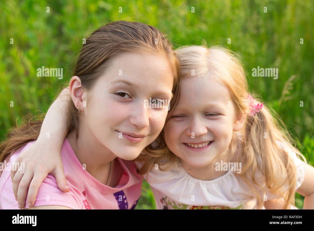 two smiling sisters. Focus on an older sister eyes Stock Photo - Alamy