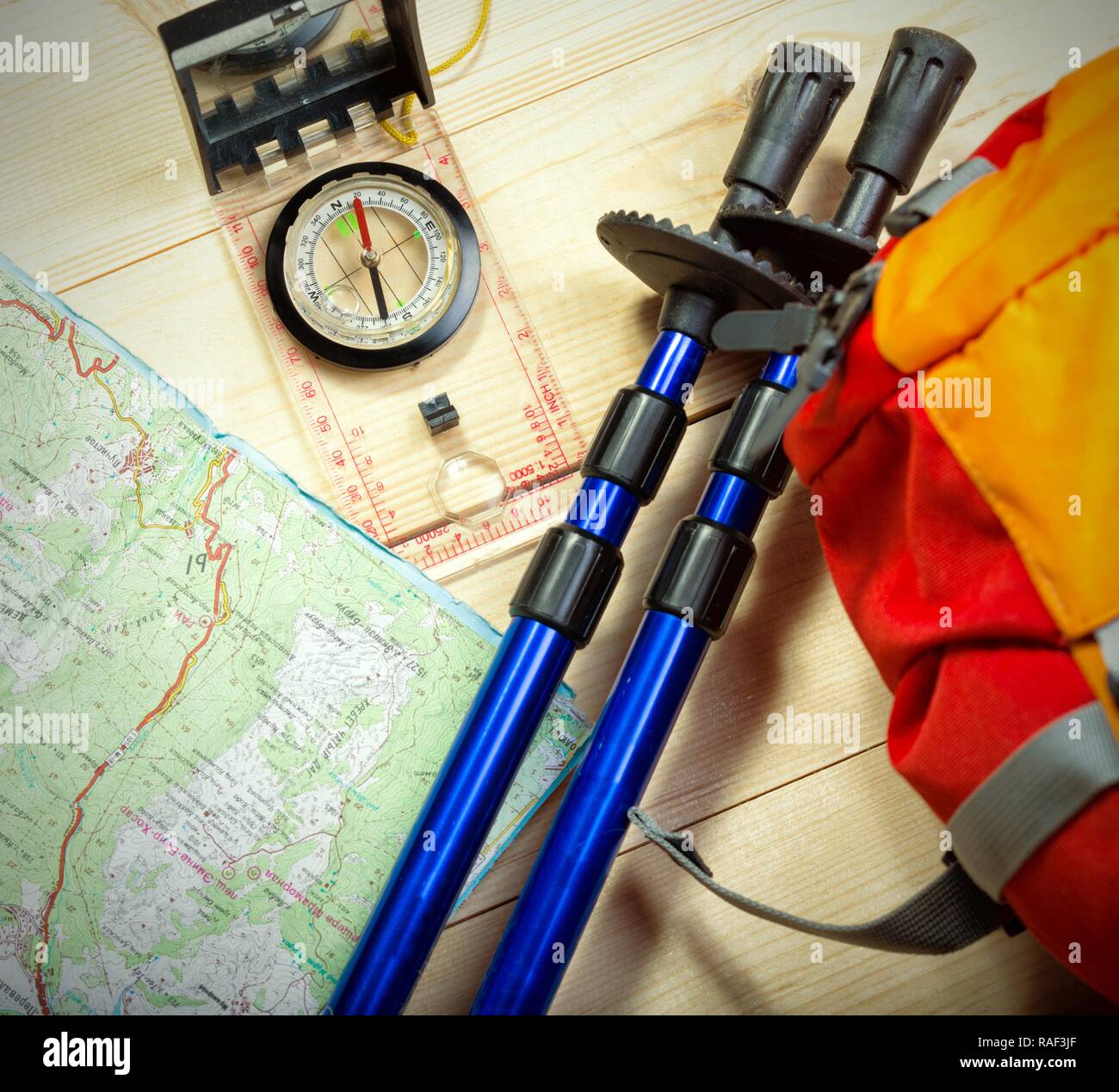 compass, map, trekking poles and backpack on a wooden background Stock ...