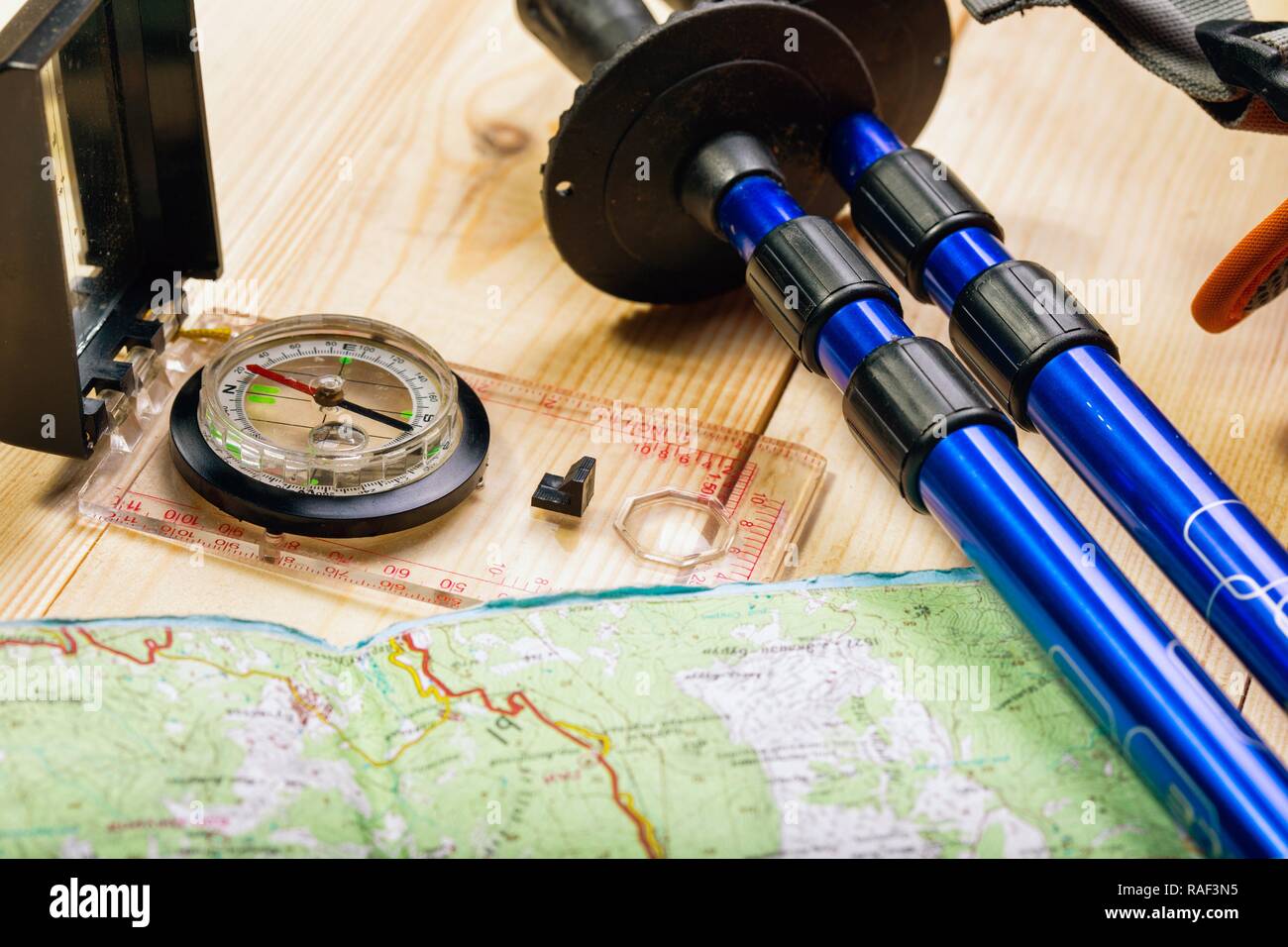 compass, map, trekking poles and backpack on a wooden background Stock ...