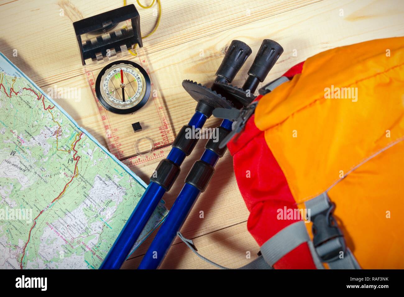 compass, map, trekking poles and backpack on a wooden background Stock ...