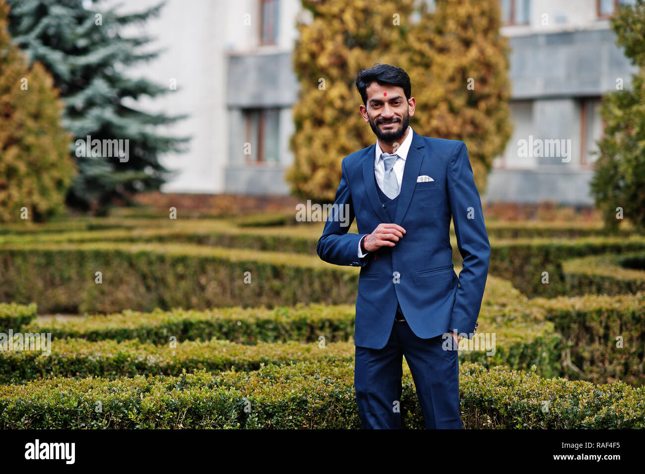 Stylish beard indian man with bindi on forehead, wear on blue suit ...