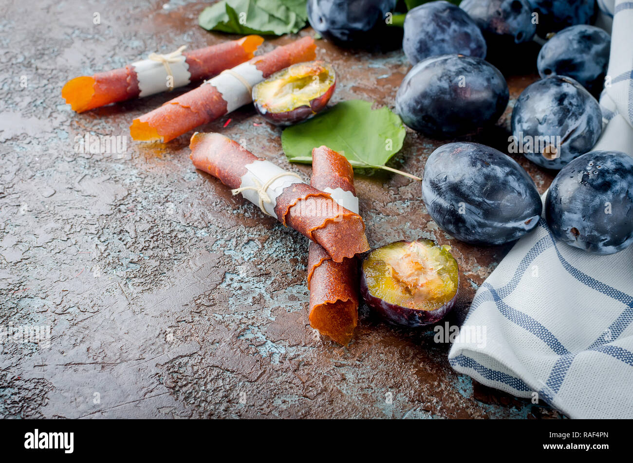 Fresh Purple Plums scattered on the table, plums in the form of dry ...