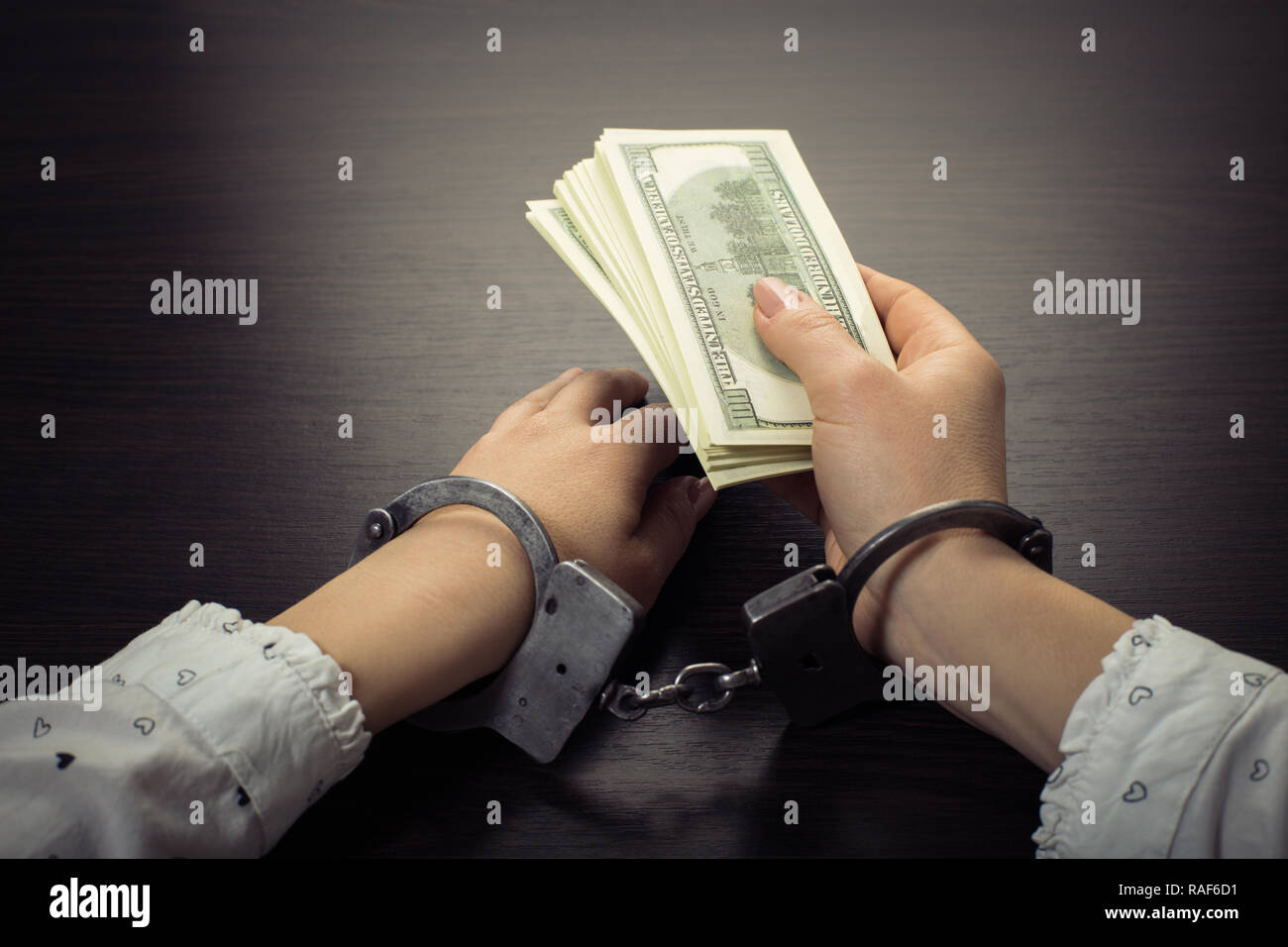 Handcuffs on hands hi-res stock photography and images - Alamy