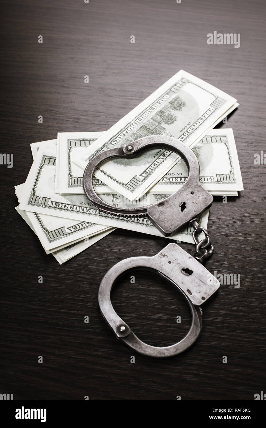Money handcuffs hi-res stock photography and images - Alamy