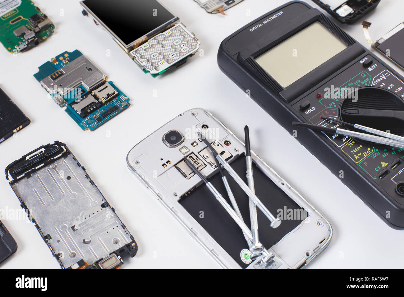 disassembled mobile phone and tools on white background Stock Photo - Alamy