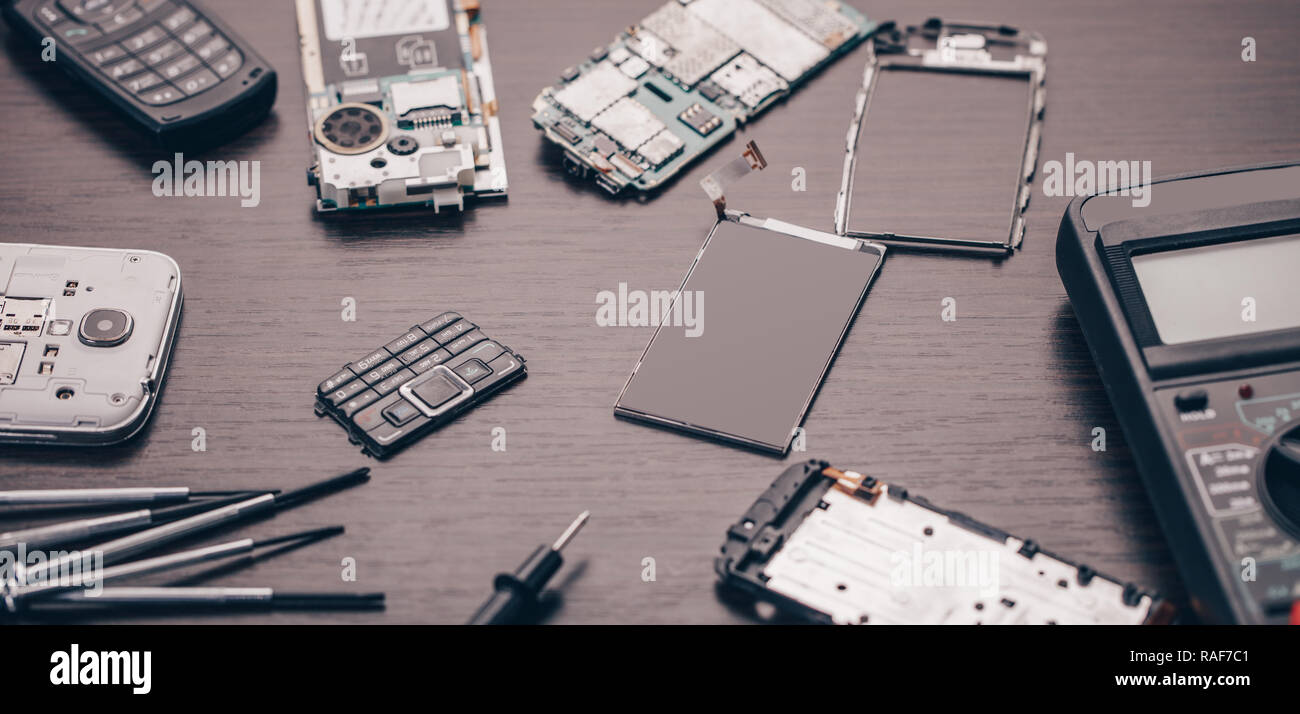 disassembled mobile phone and tools on wooden background Stock Photo ...