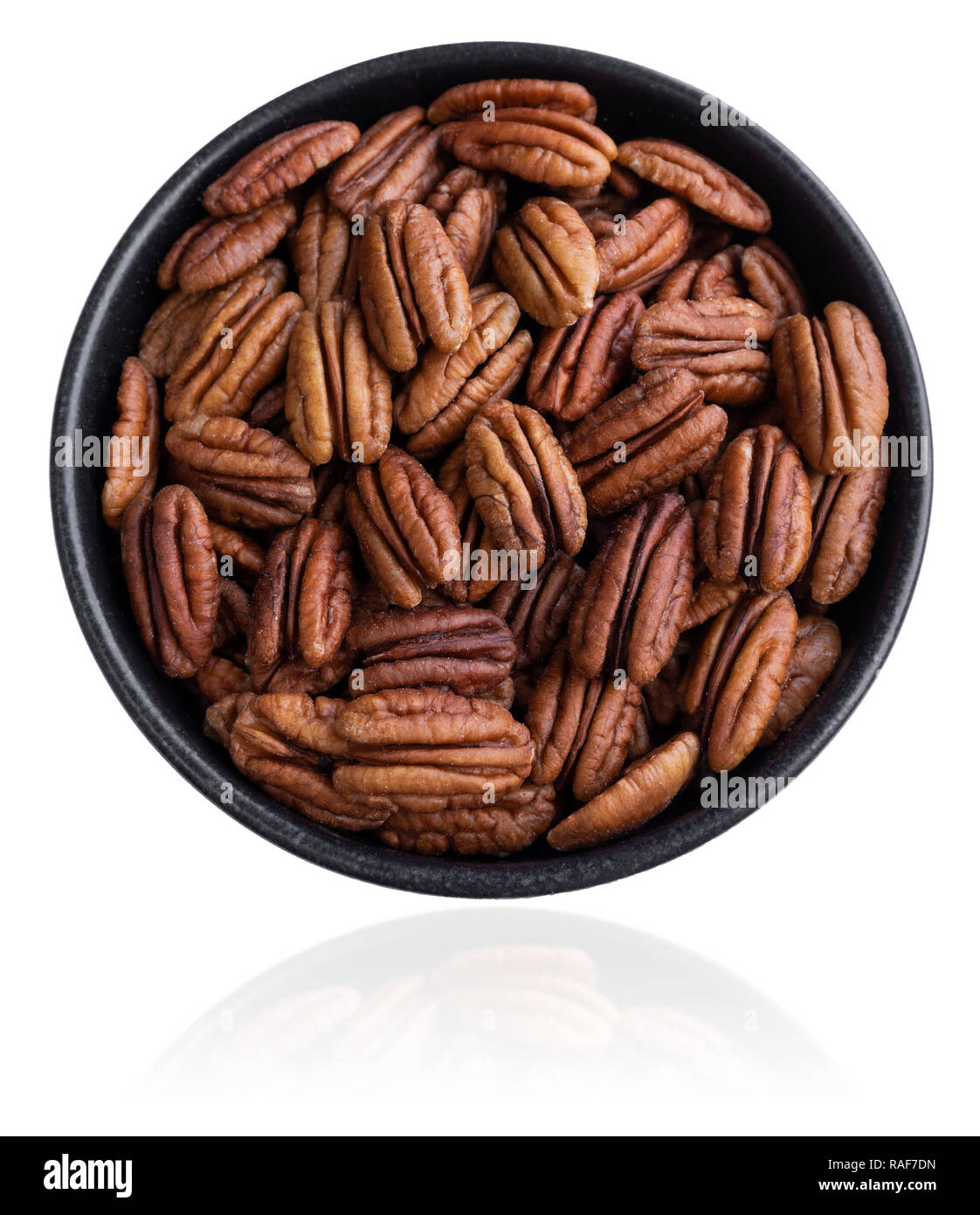 Close-up View of Pecan Kernels in a Bowl isolated on a white Background ...