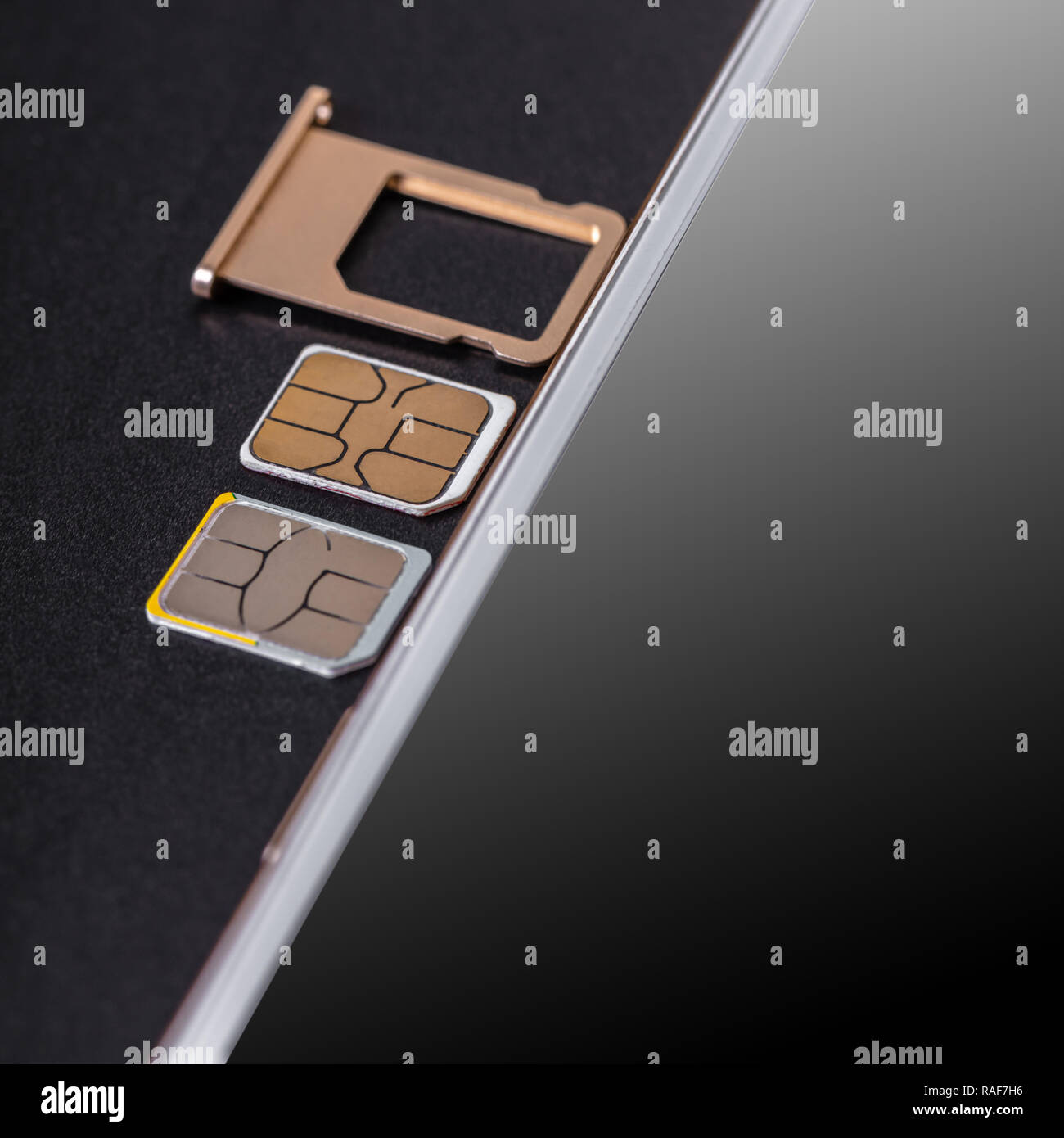 mobile phone and sim card on a black background Stock Photo - Alamy