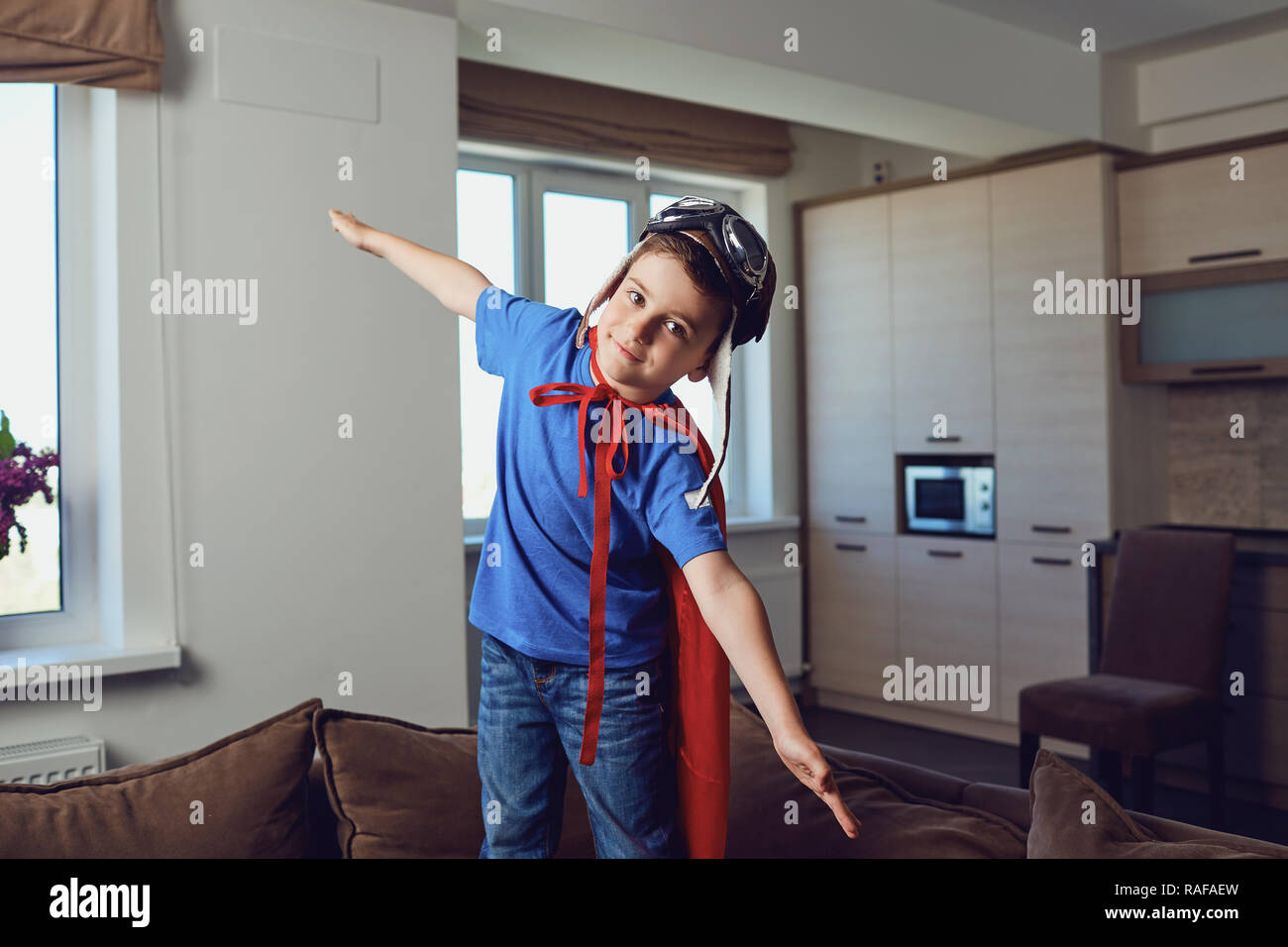 The boy in the costume of a superhero at the window Stock Photo - Alamy