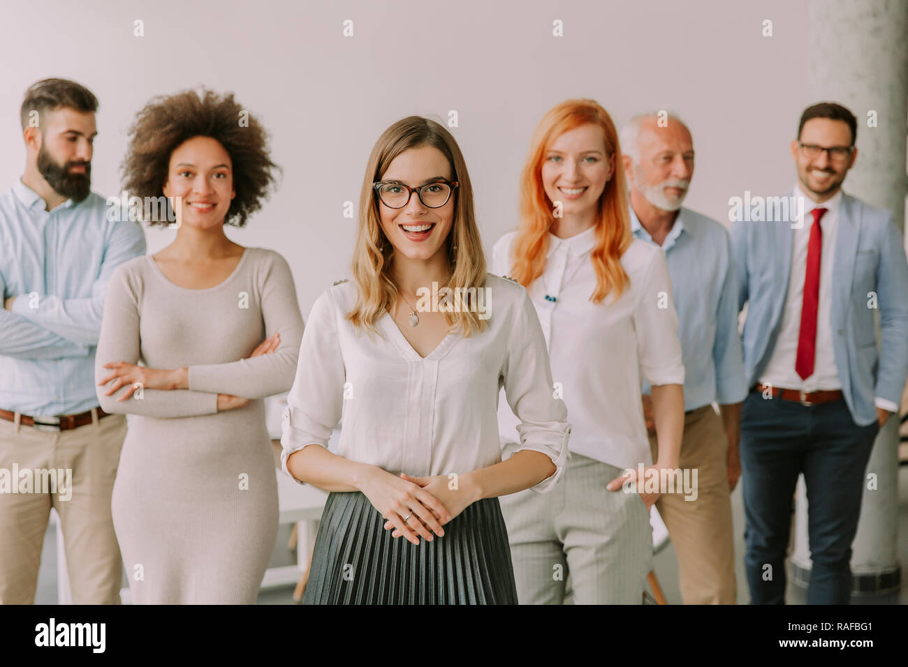 Line of happy and positive business people standing in the office Stock ...
