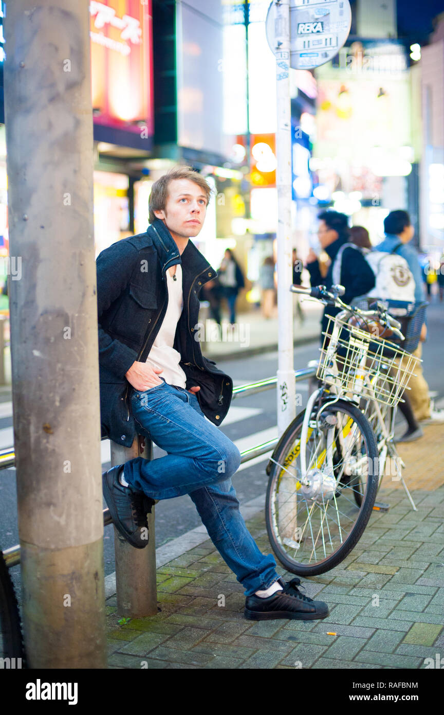 Caucasian male model poses for pictures on the street Stock Photo - Alamy