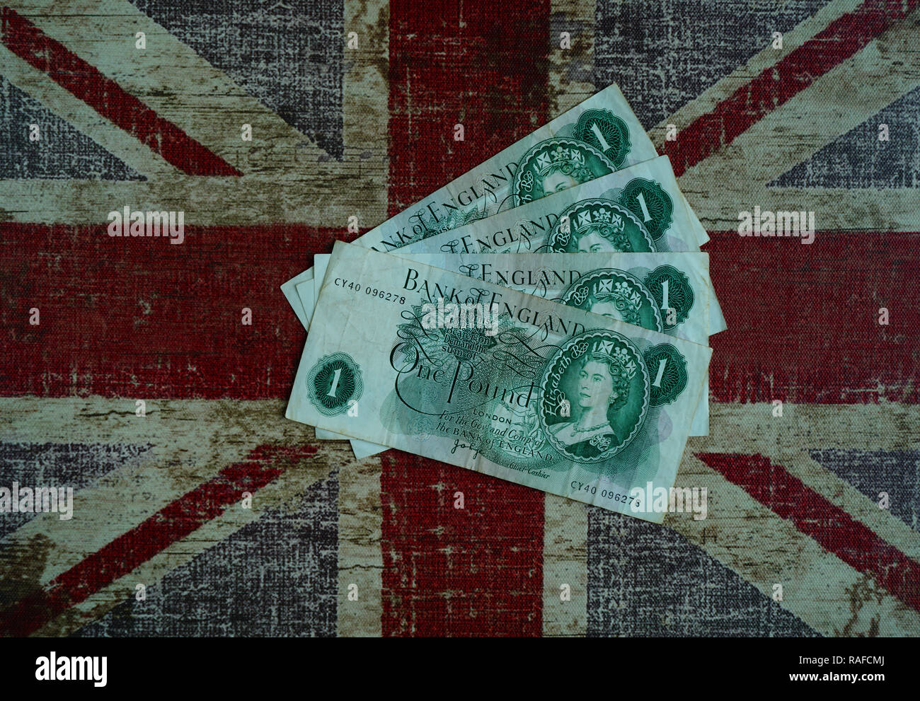 4 old money one pound notes on a union jack Stock Photo - Alamy