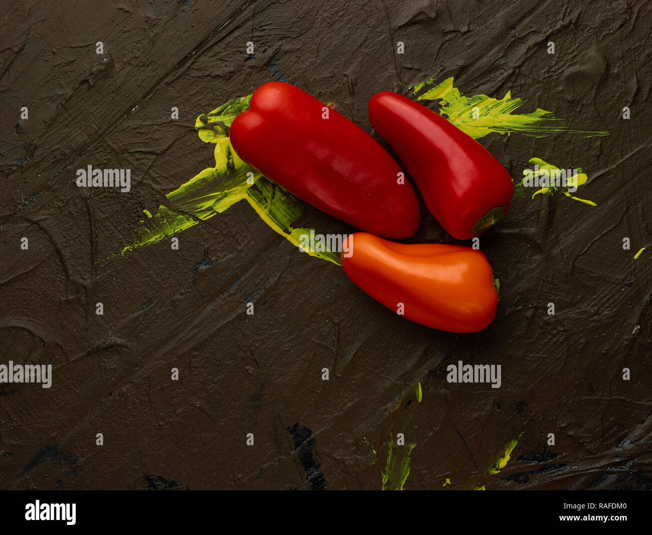 Mini sweet capsicum pepper against dark background with yellow flecks ...