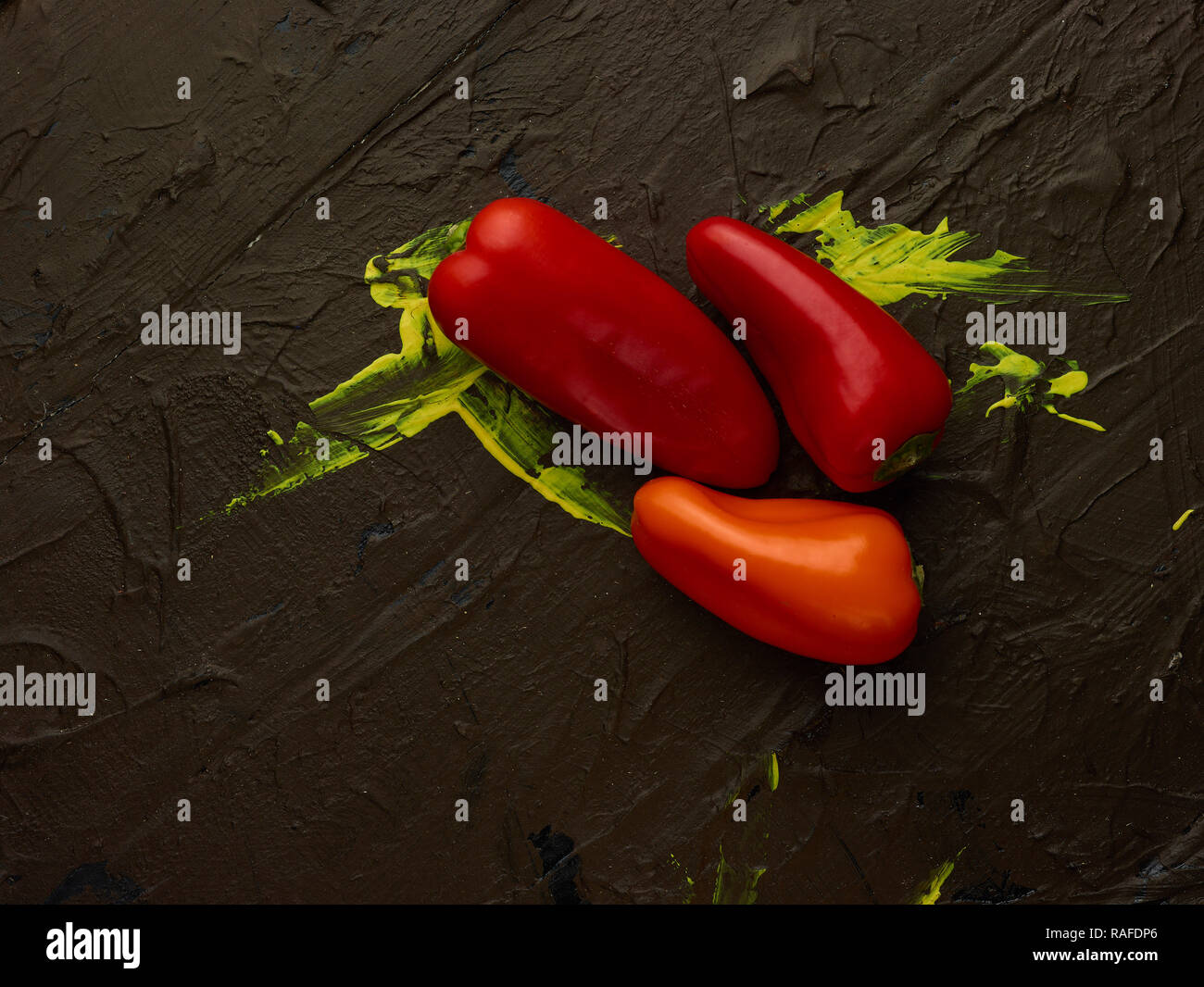 Mini sweet capsicum pepper against dark background with yellow flecks ...