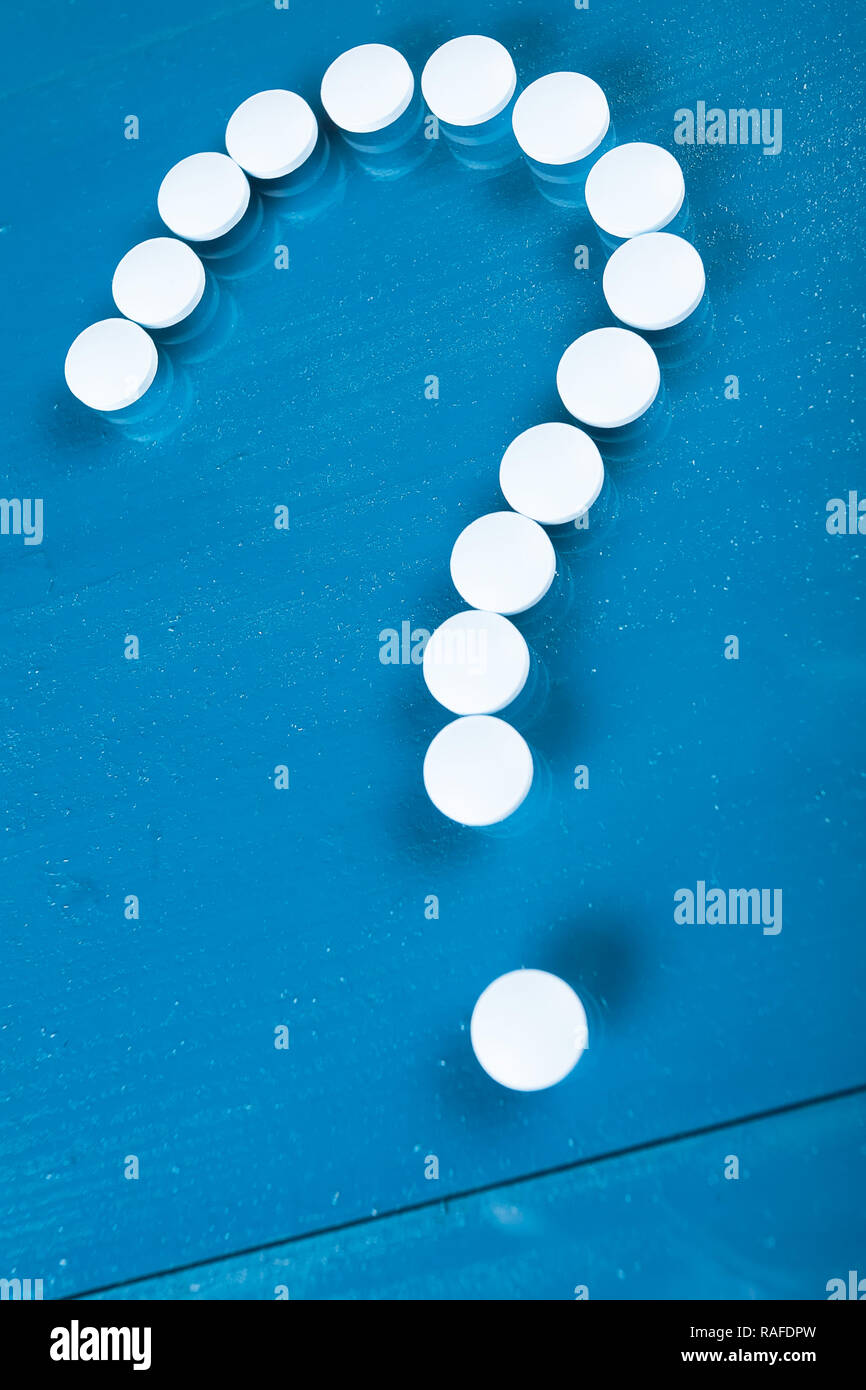 Pills question mark vintage blue natural wood background Stock Photo ...