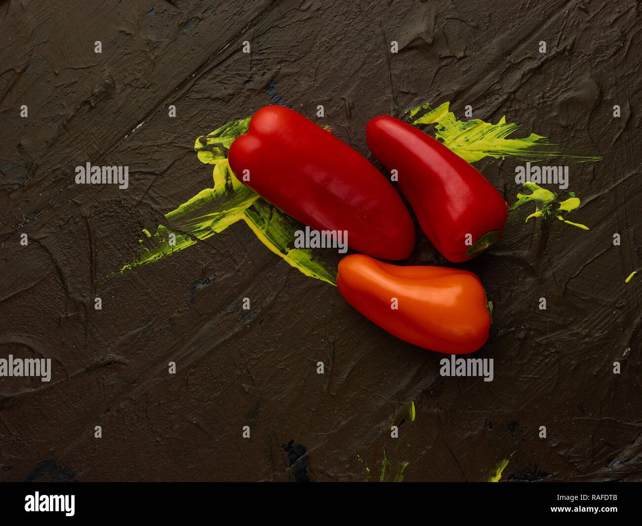 Mini sweet capsicum pepper against dark background with yellow flecks ...
