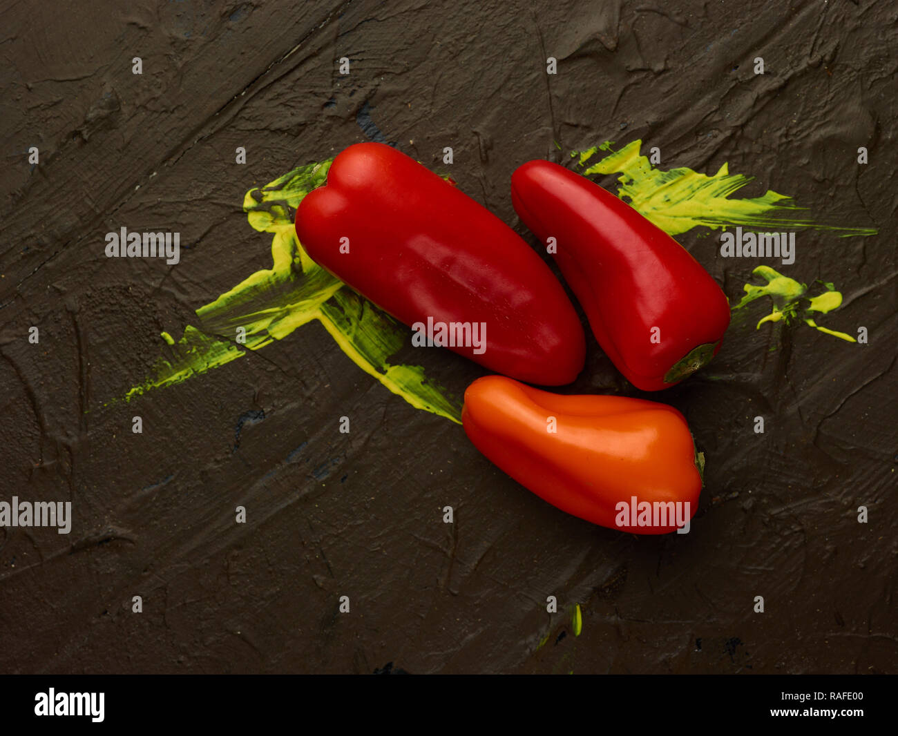 Mini sweet capsicum pepper against dark background with yellow flecks ...