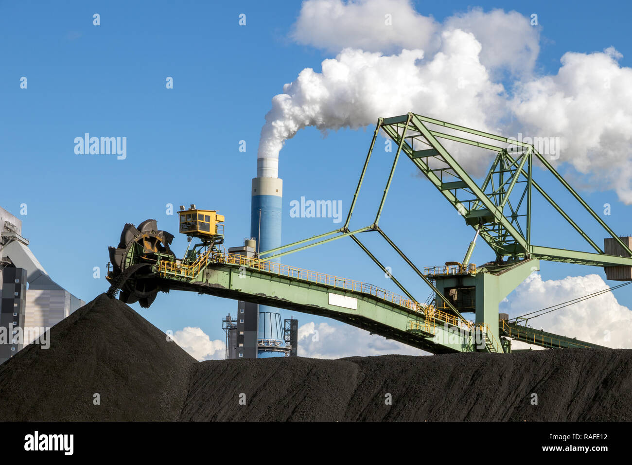 Stacker-reclaimer in a coal handling terminal with in the background a ...