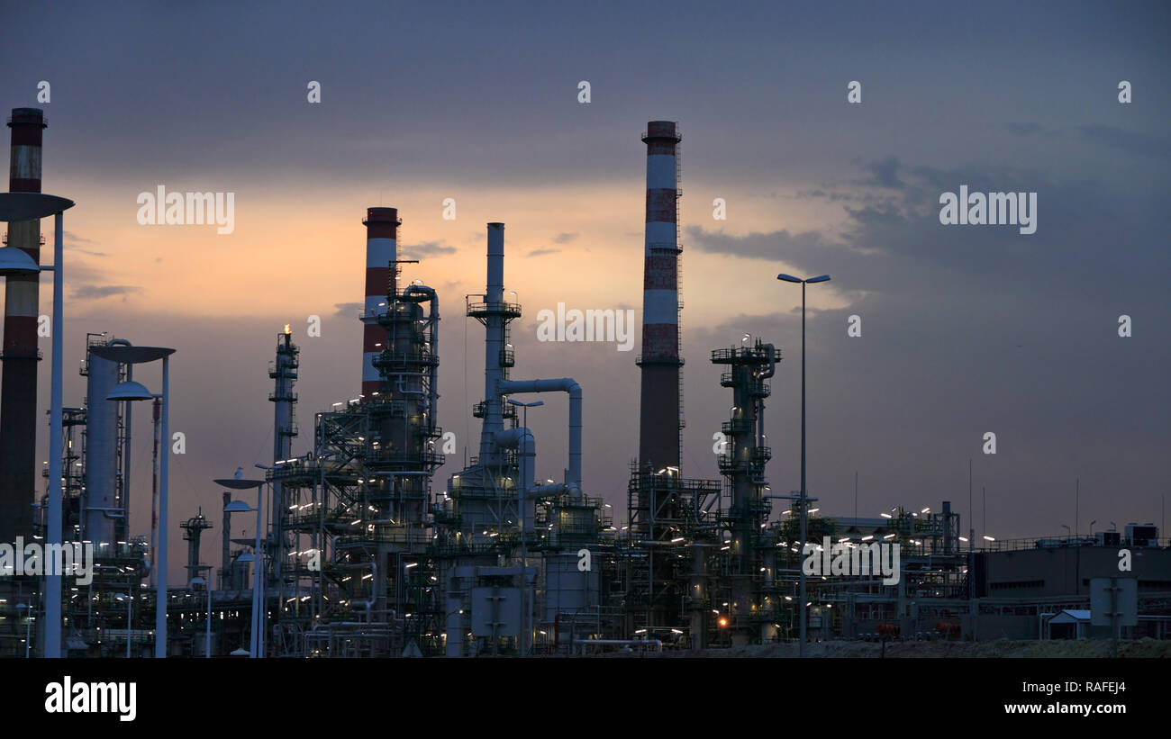 Panorama of an oil refinery near a road in the early morning light ...