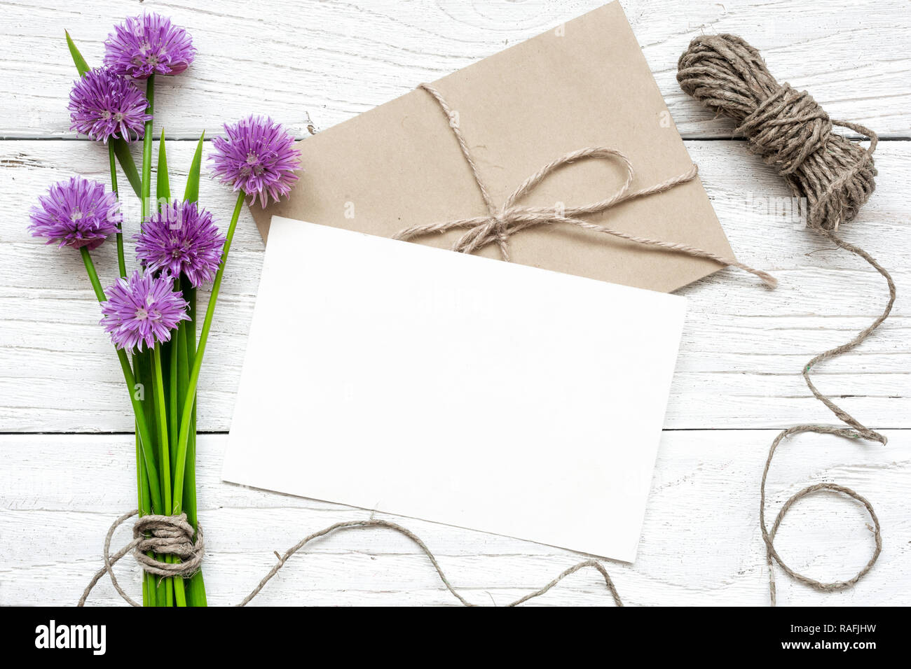 blank white greeting card with purple wildflowers bouquet and envelope ...