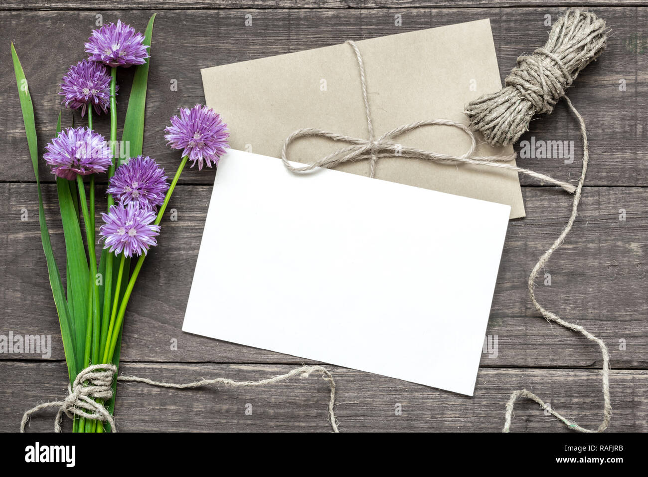 blank white greeting card with purple wildflowers bouquet and envelope ...