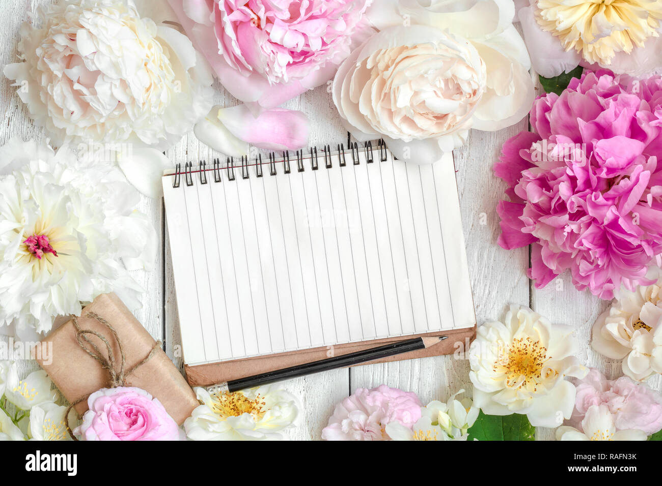 blank lined notebook in flower frame made of pink and white peony ...