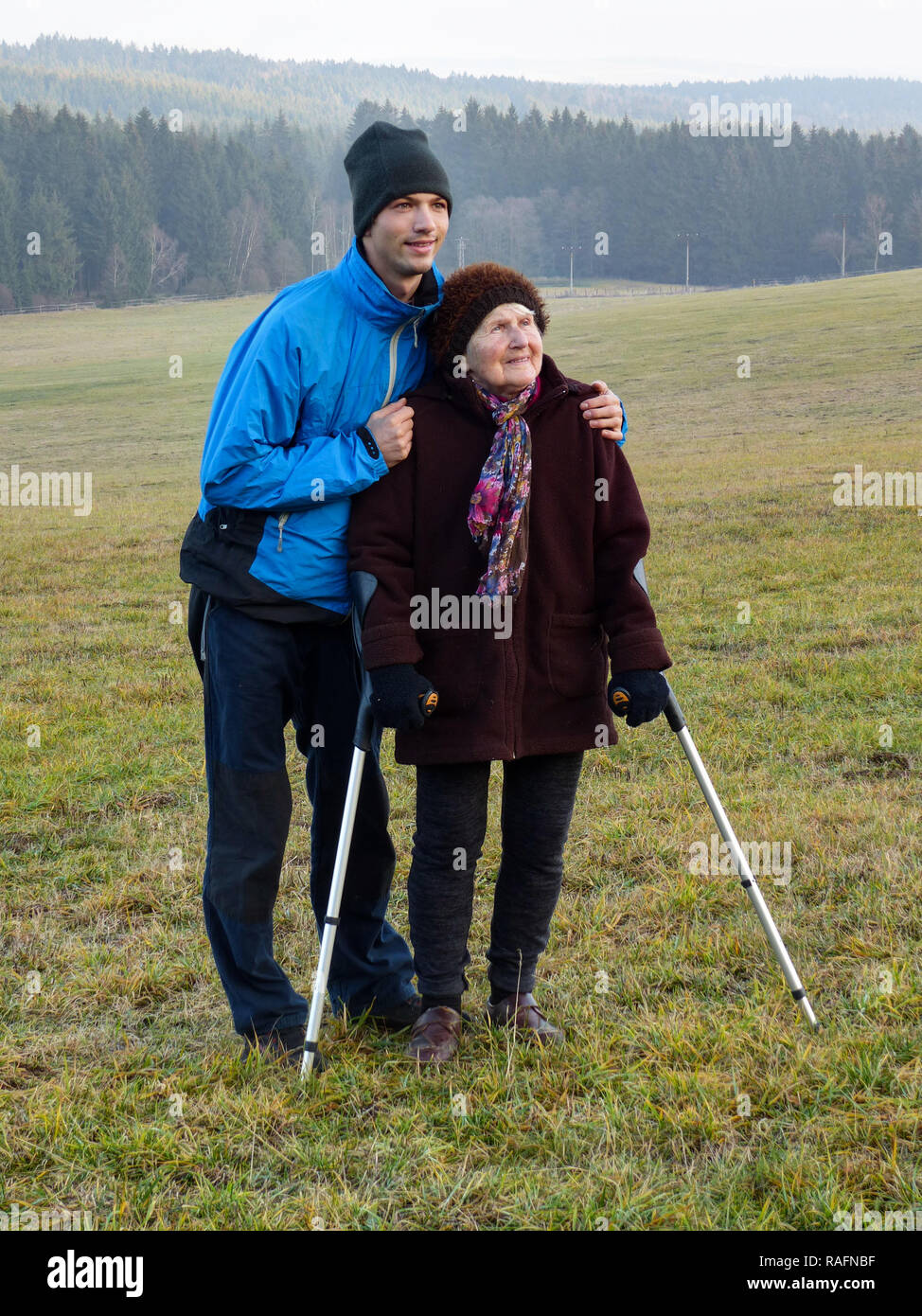 Kind young man take his grandmother for a walk to make her happy Stock ...