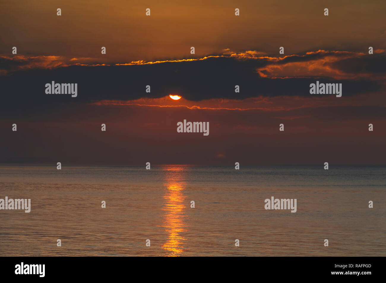 The sun appear from behind cloud-cover Stock Photo - Alamy