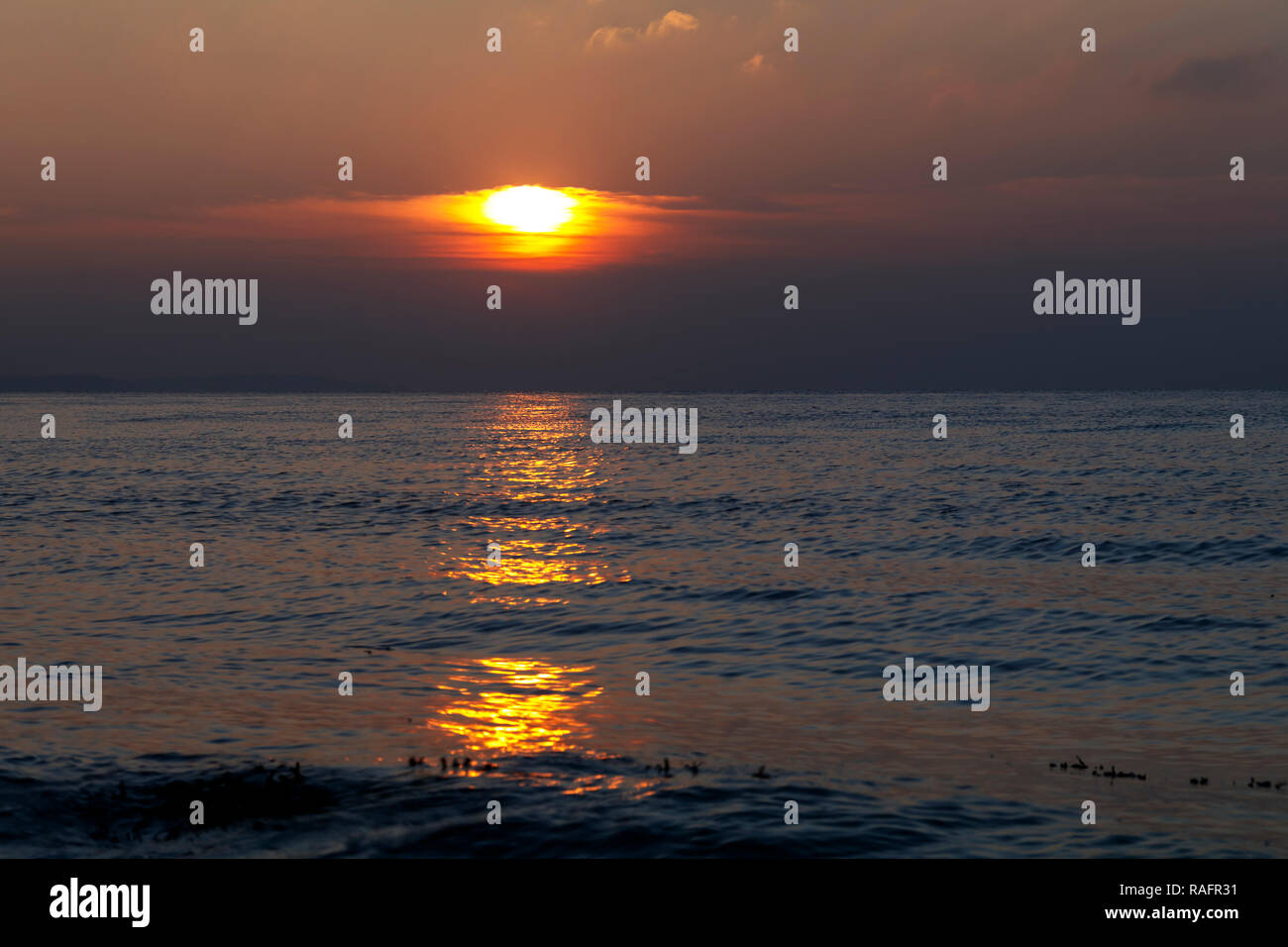 Streak of sunlight going across the sea Stock Photo - Alamy