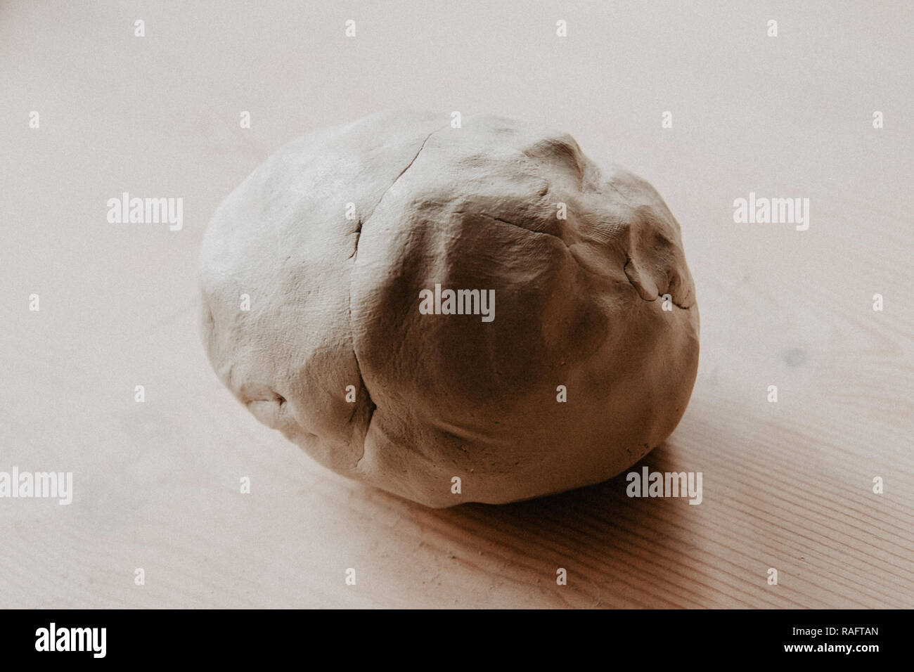 A piece of clay on table on a wood background Stock Photo - Alamy