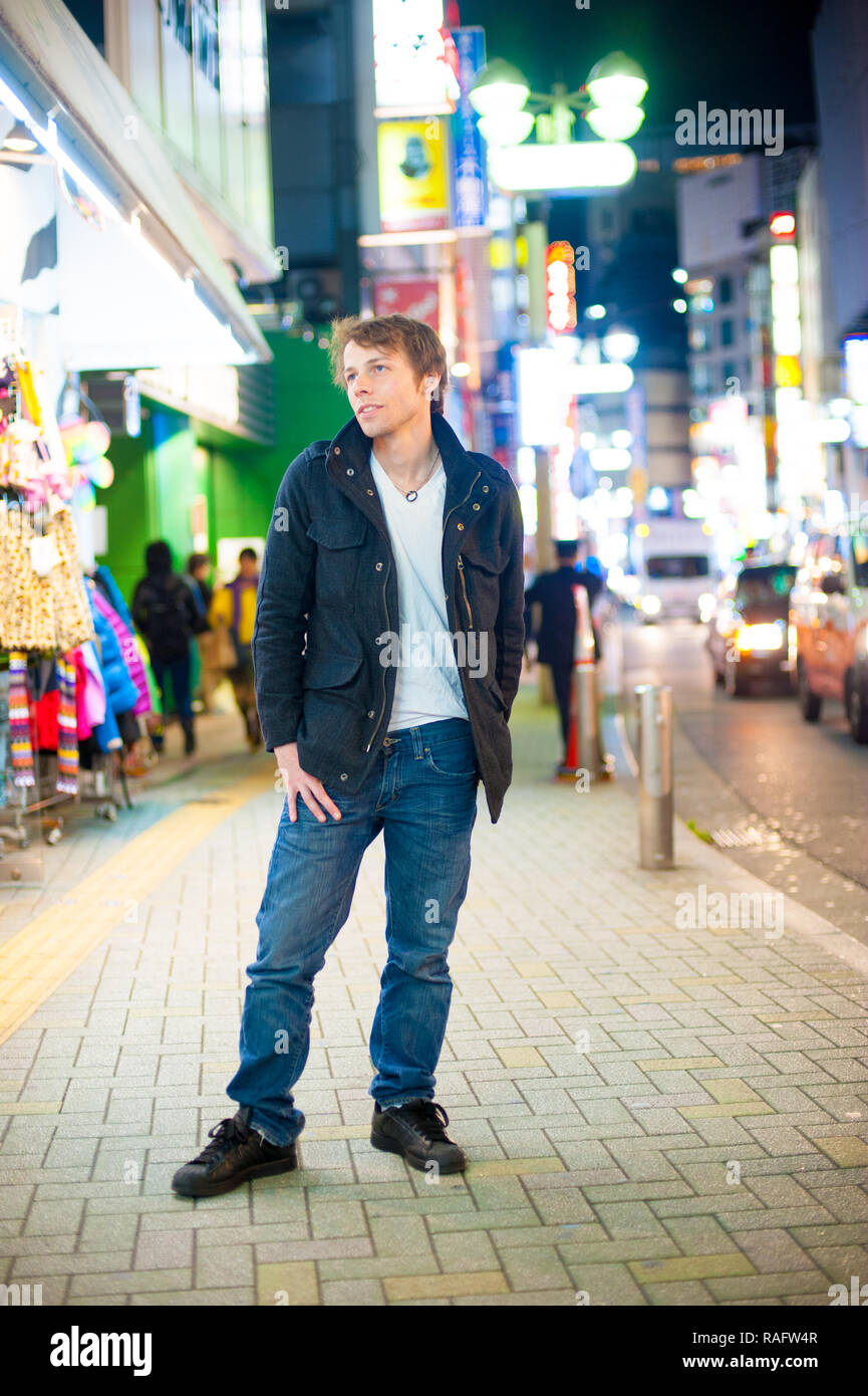 Caucasian male model poses for pictures on the street Stock Photo - Alamy