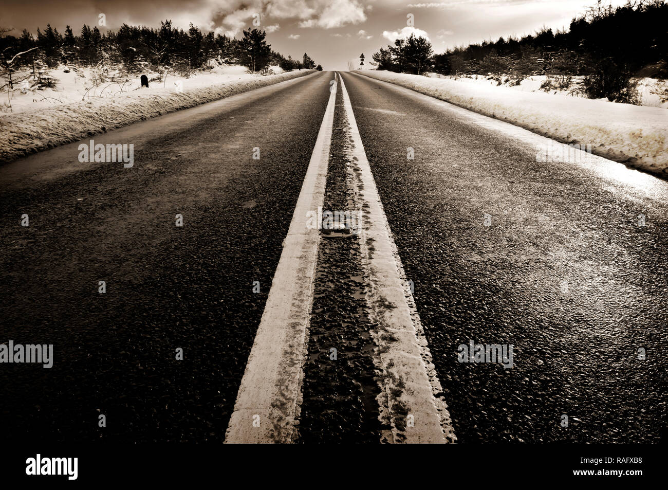 deserted desolate winding roads with snow and ice disappearing into the ...