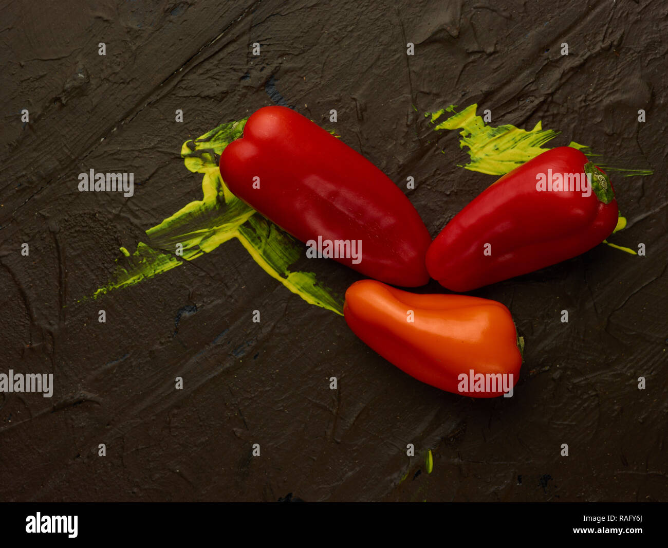 Mini sweet capsicum pepper against dark background with yellow flecks ...