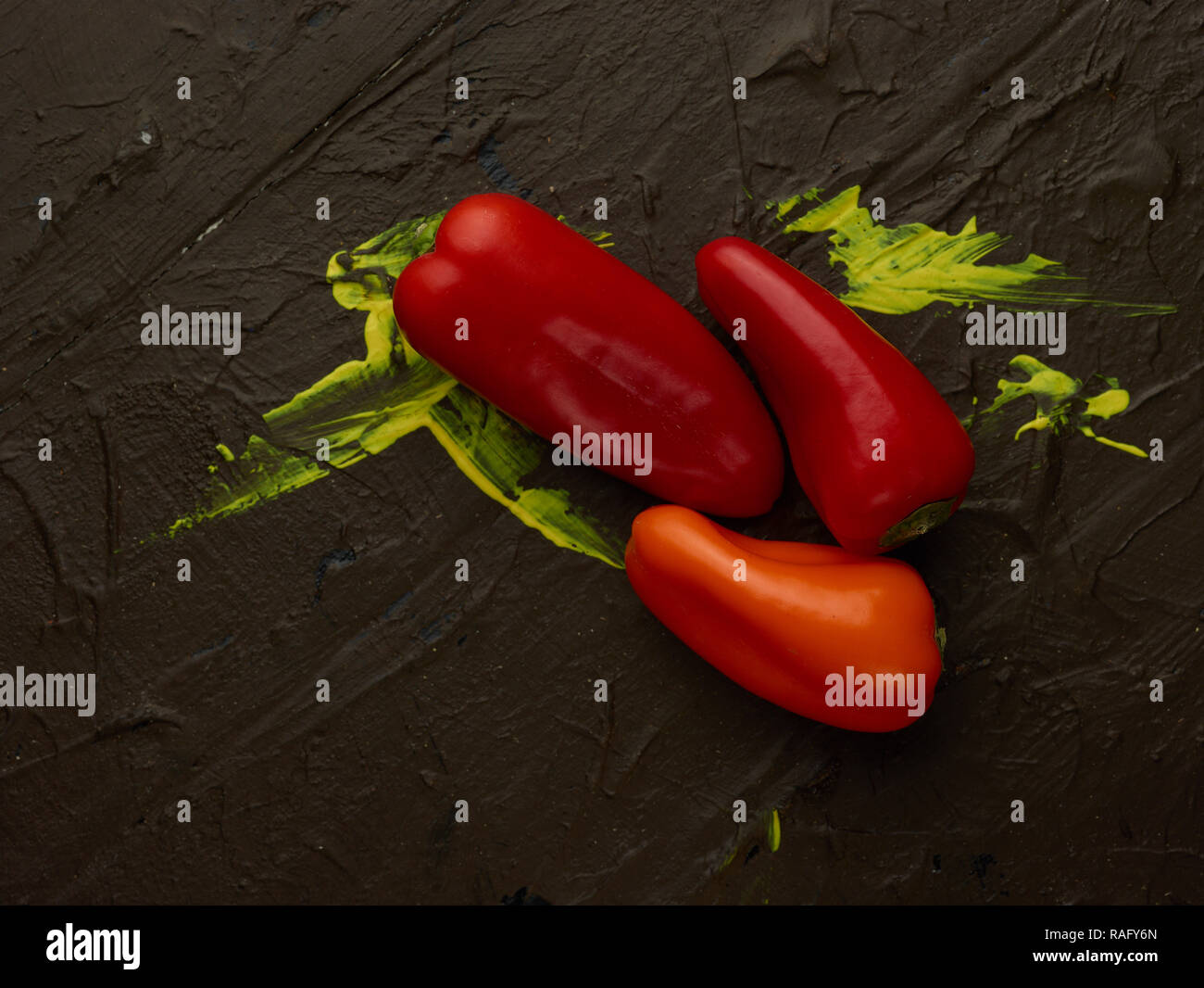 Mini sweet capsicum pepper against dark background with yellow flecks ...